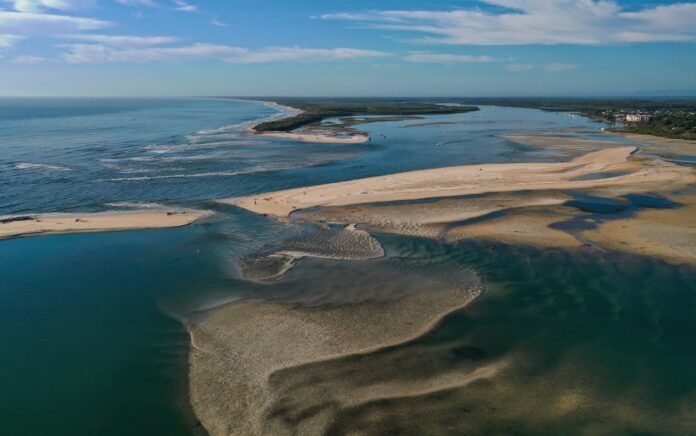 Spit splits: water rushes through giant sand bar