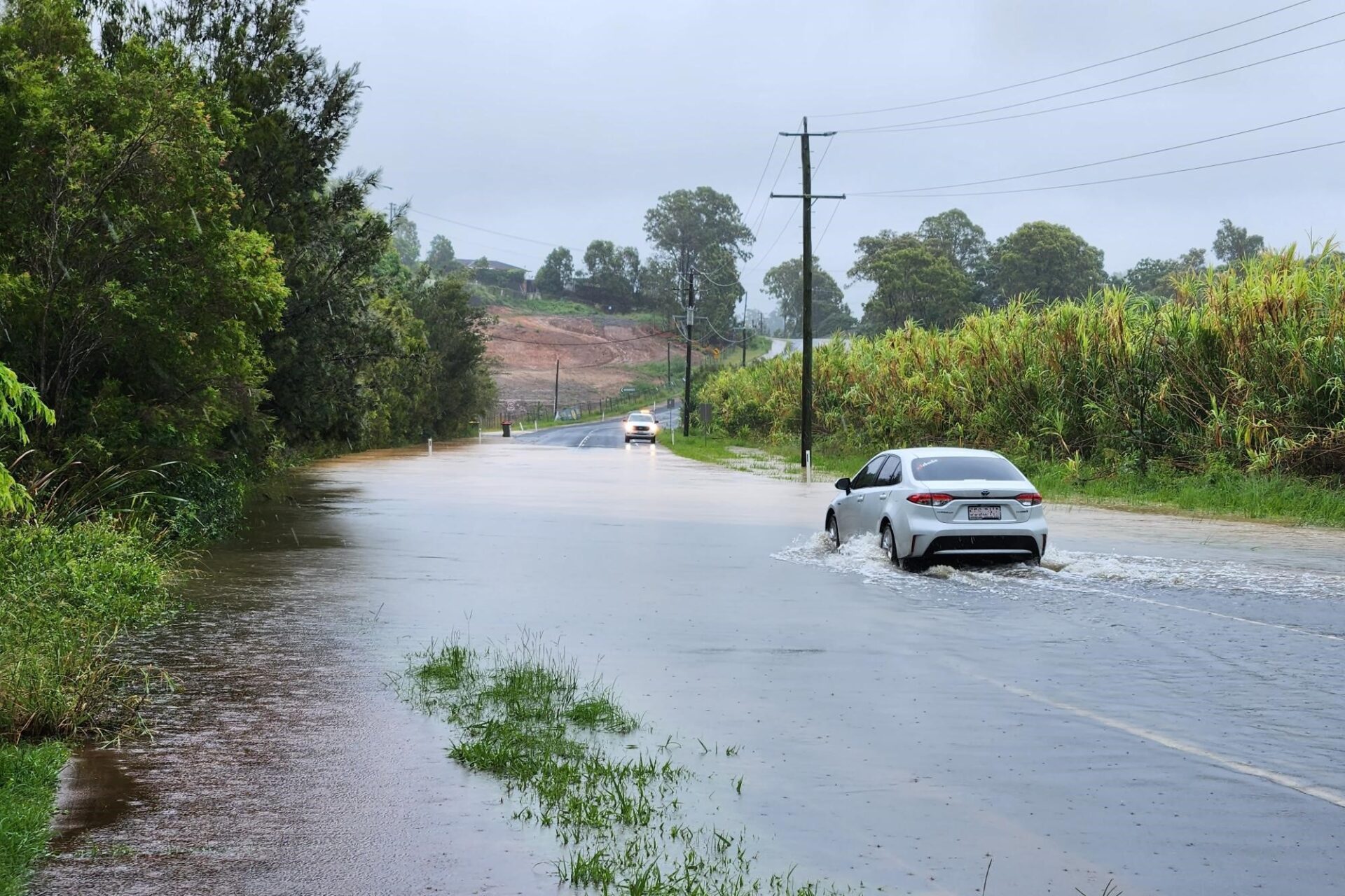 Man rescued from floodwaters after rain lashes Coast