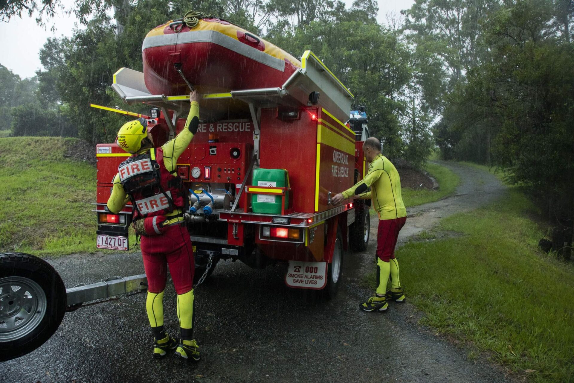 Swiftwater rescue crew scoops people from tree and tractor