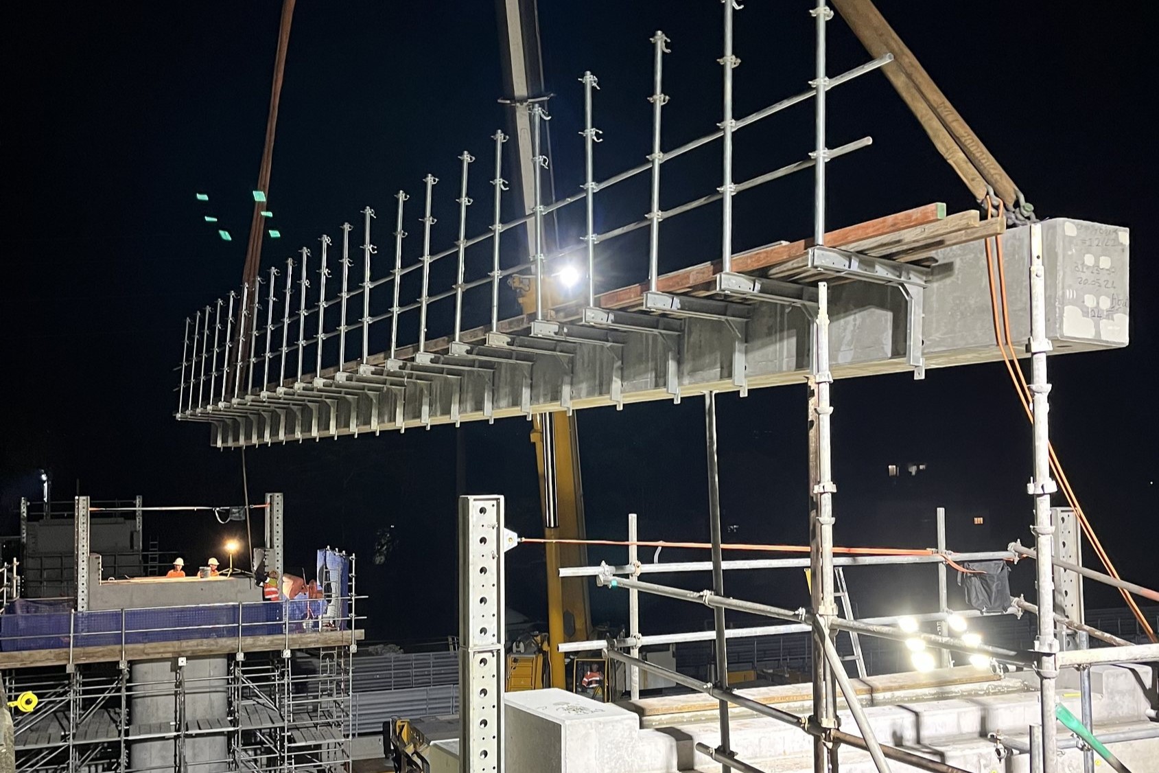 Milestone for pedestrian bridge over motorway