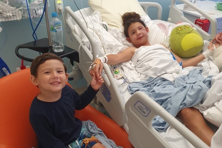 Girl severely hurt in crash praised for shielding brother